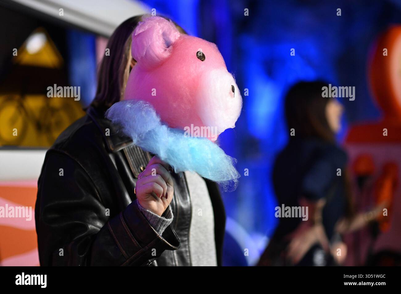 Guest pose with custom cotton candy creations at the alice & olivia by ...
