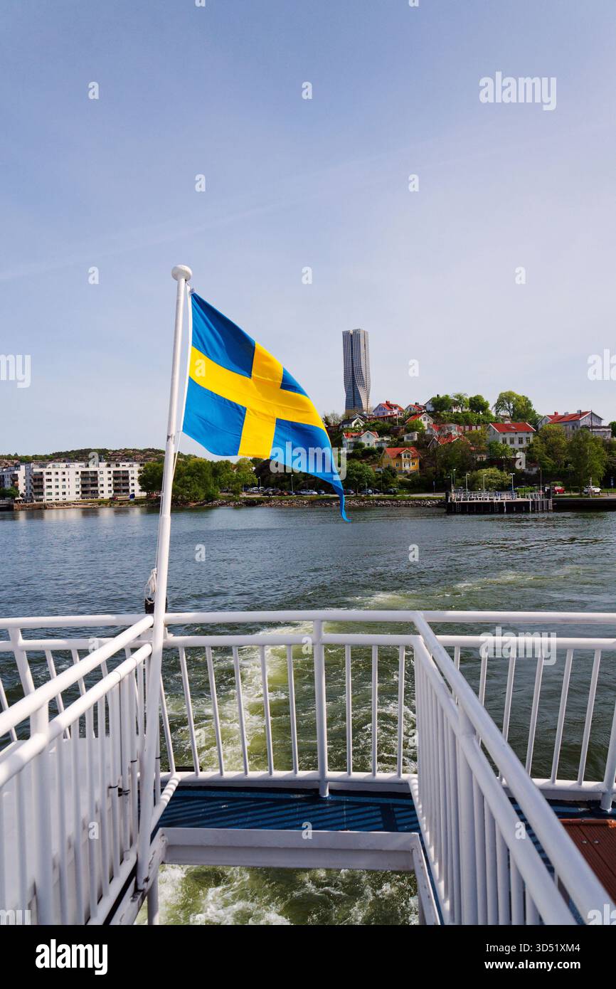 Swedish flag with colony of small wooden historic houses on the ...