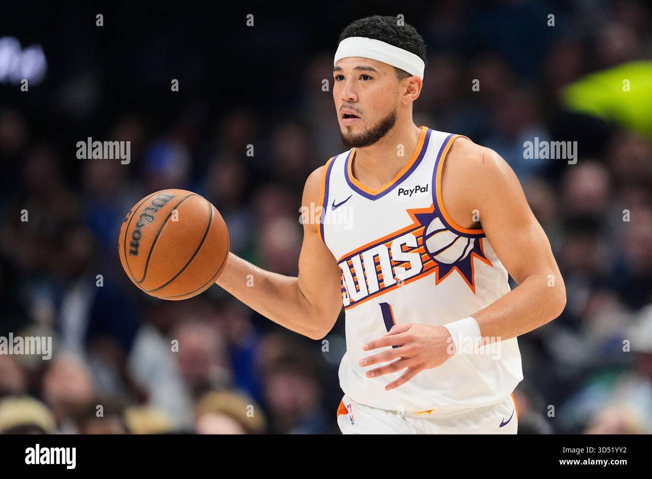 Phoenix Suns' Devin Booker handles the ball during an NBA basketball ...