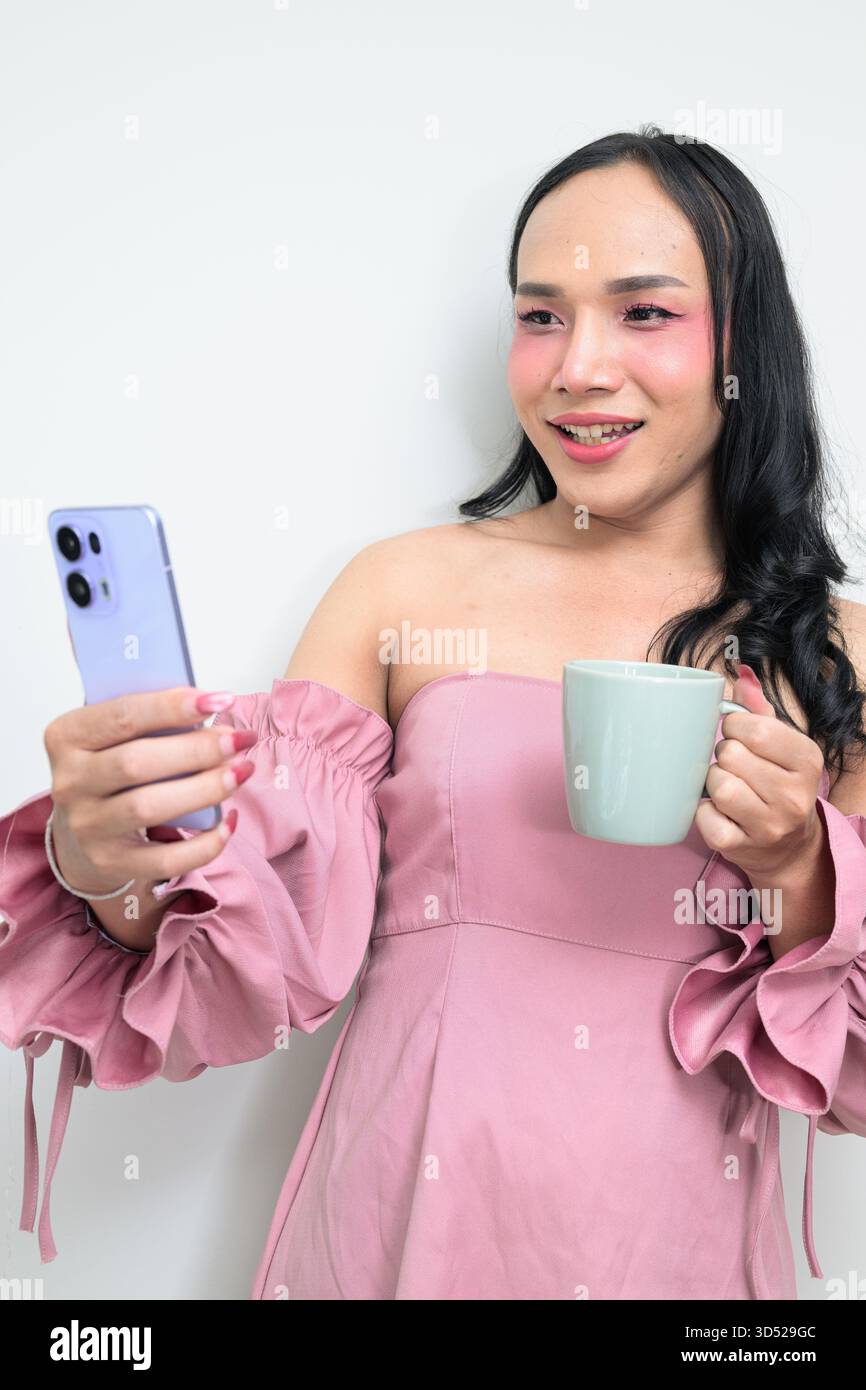 Studio portrait of a young Thai transgender individual with makeup and ...