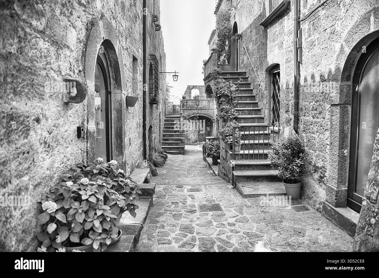 A narrow, picturesque cobblestone street in Civita di Bagnoregio, Italy ...