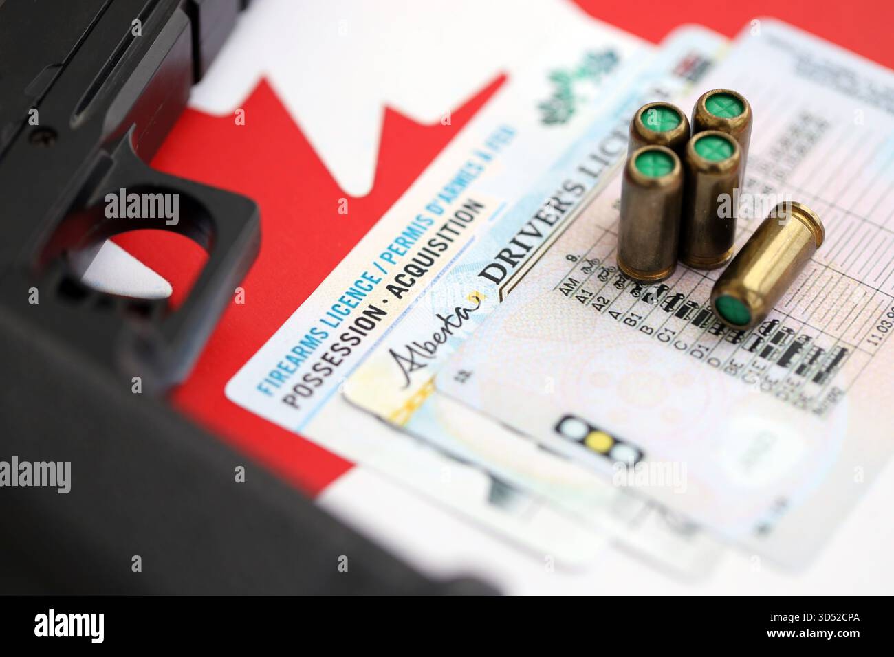 Canadian firearms license and handgun with bullets on Canadian flag ...