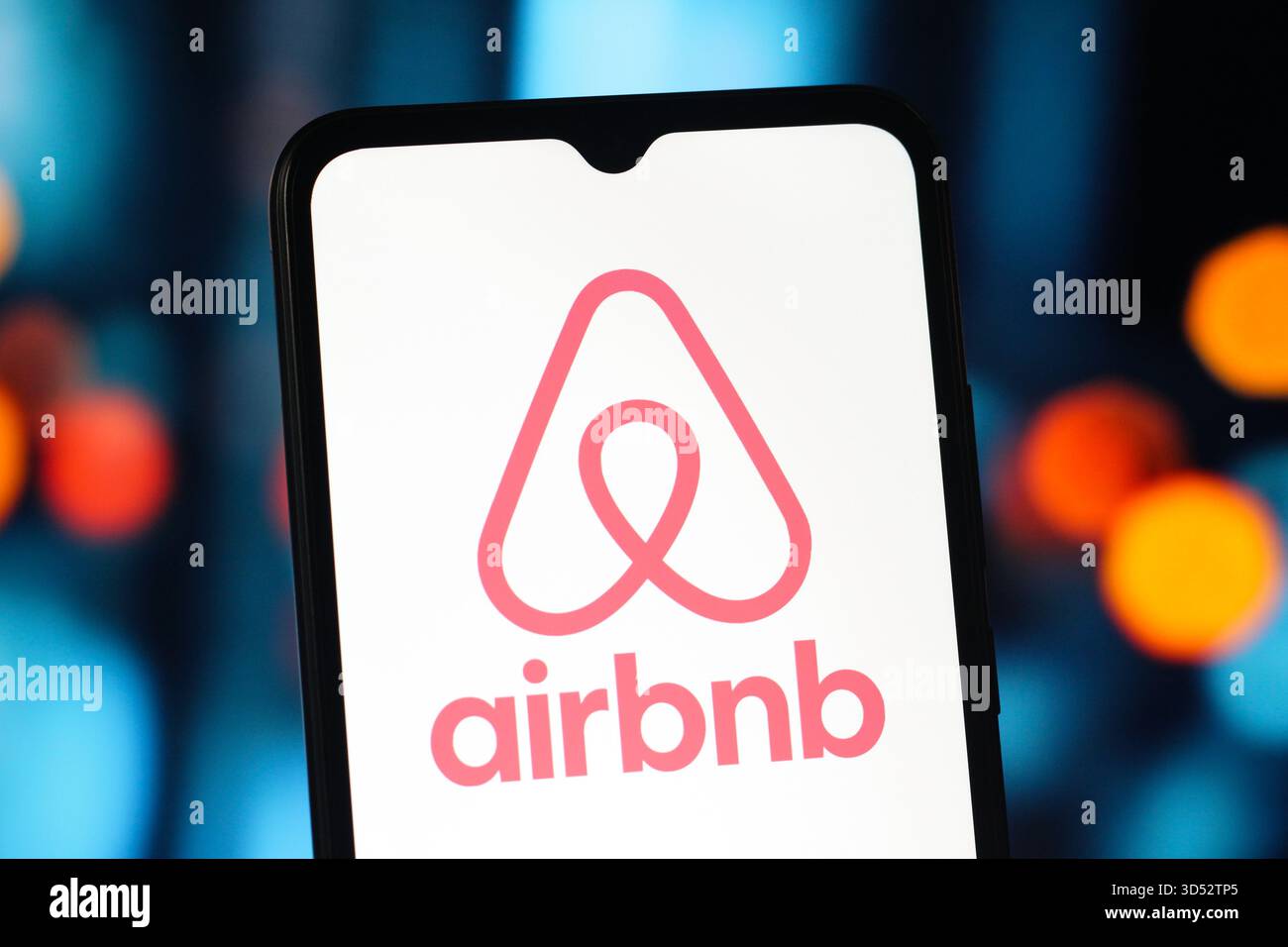 In this photo illustration, the Airbnb logo is seen displayed on a ...