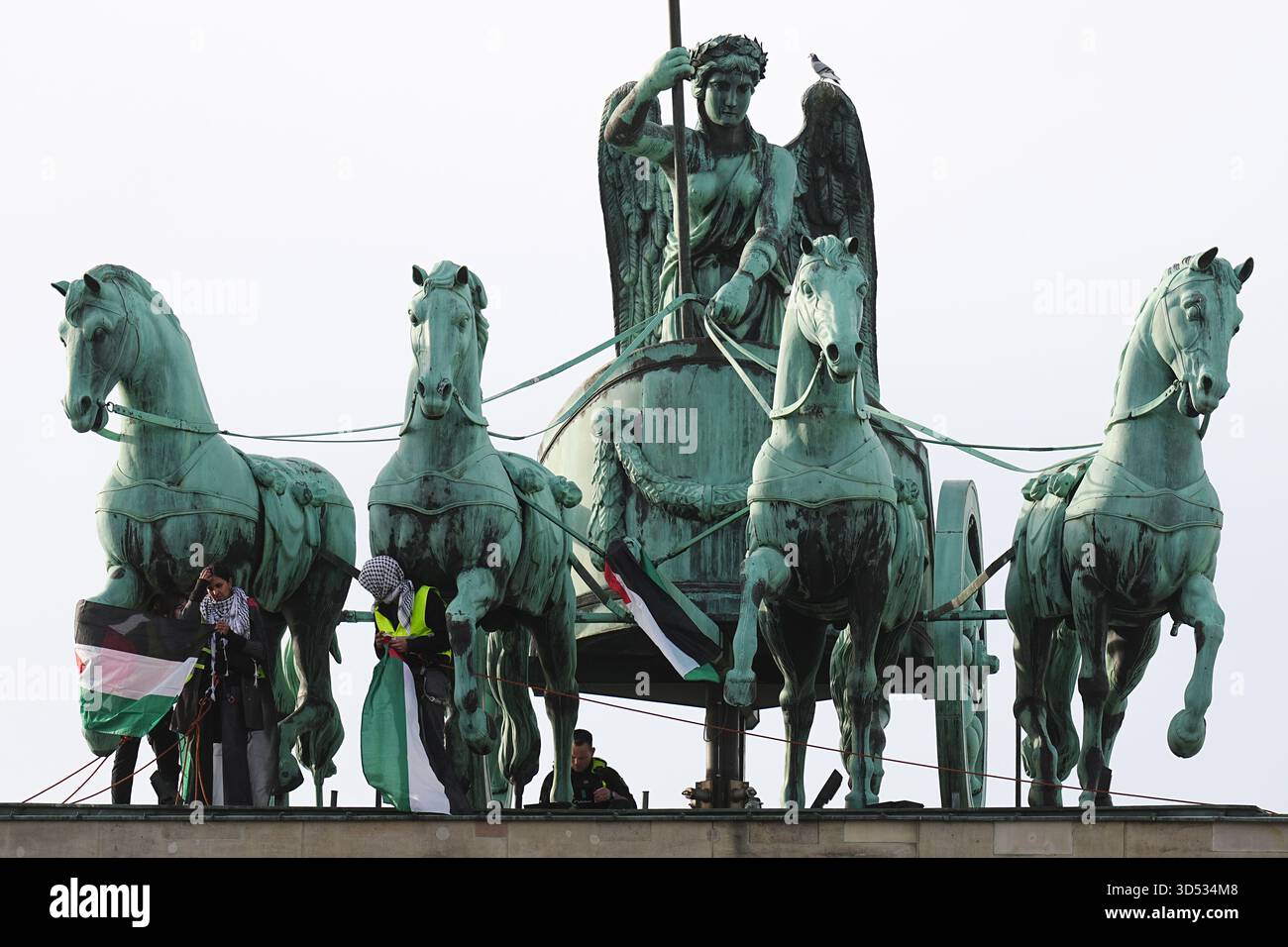 13 November 2025, Berlin: Several demonstrators climbed onto the ...