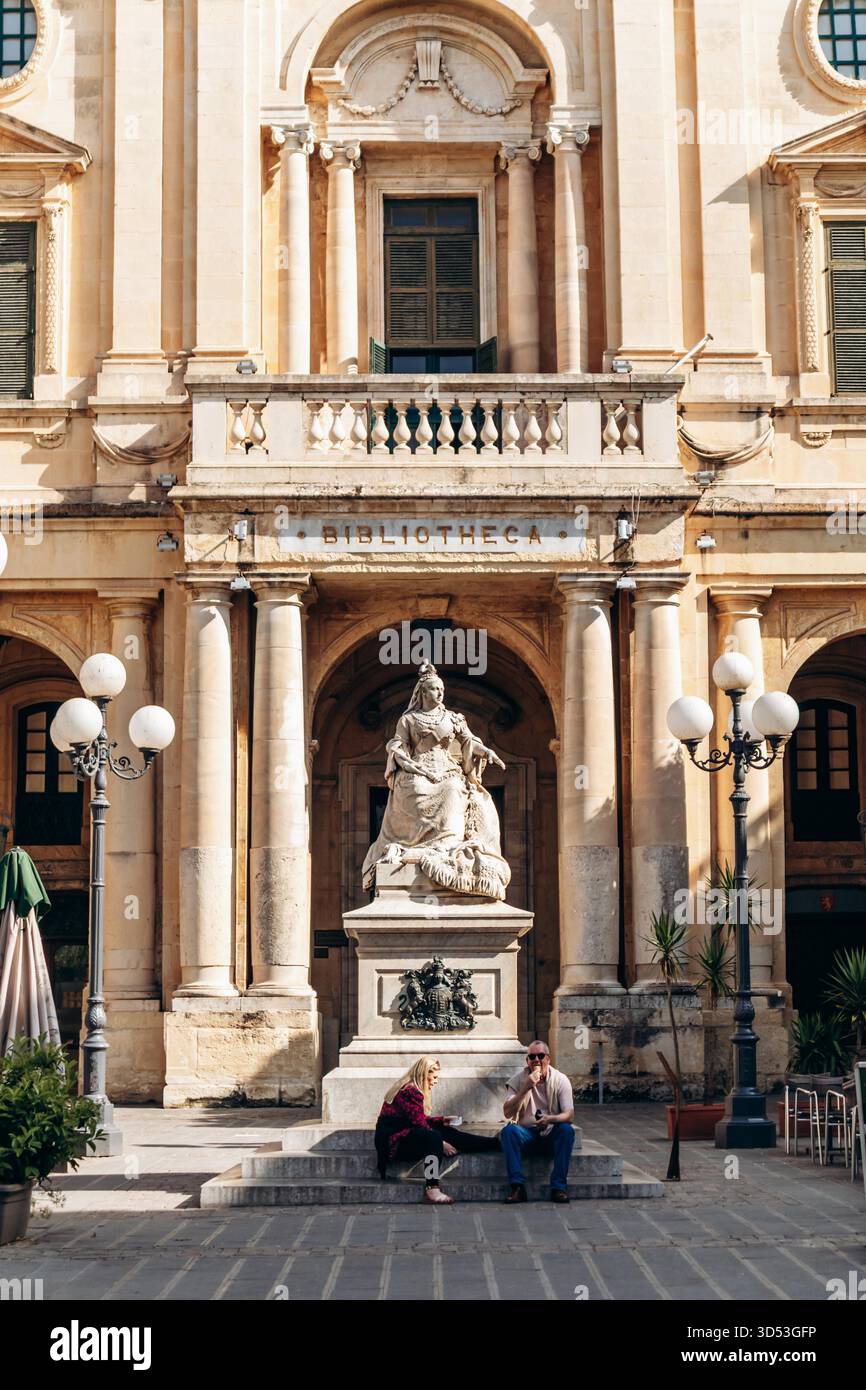 Valletta, Malta - April 10, 2025: The statue of Queen Victoria seated ...