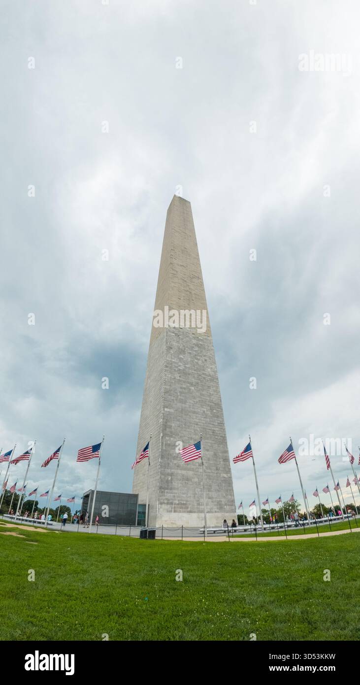 The Washington Monument is a tall, gray structure with flags flying ...
