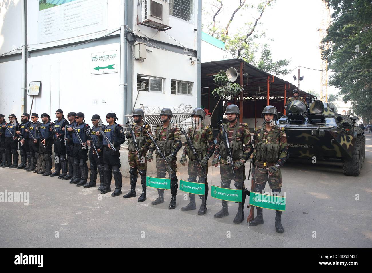 Bangladeshi security personnel stand guard in front of the ...