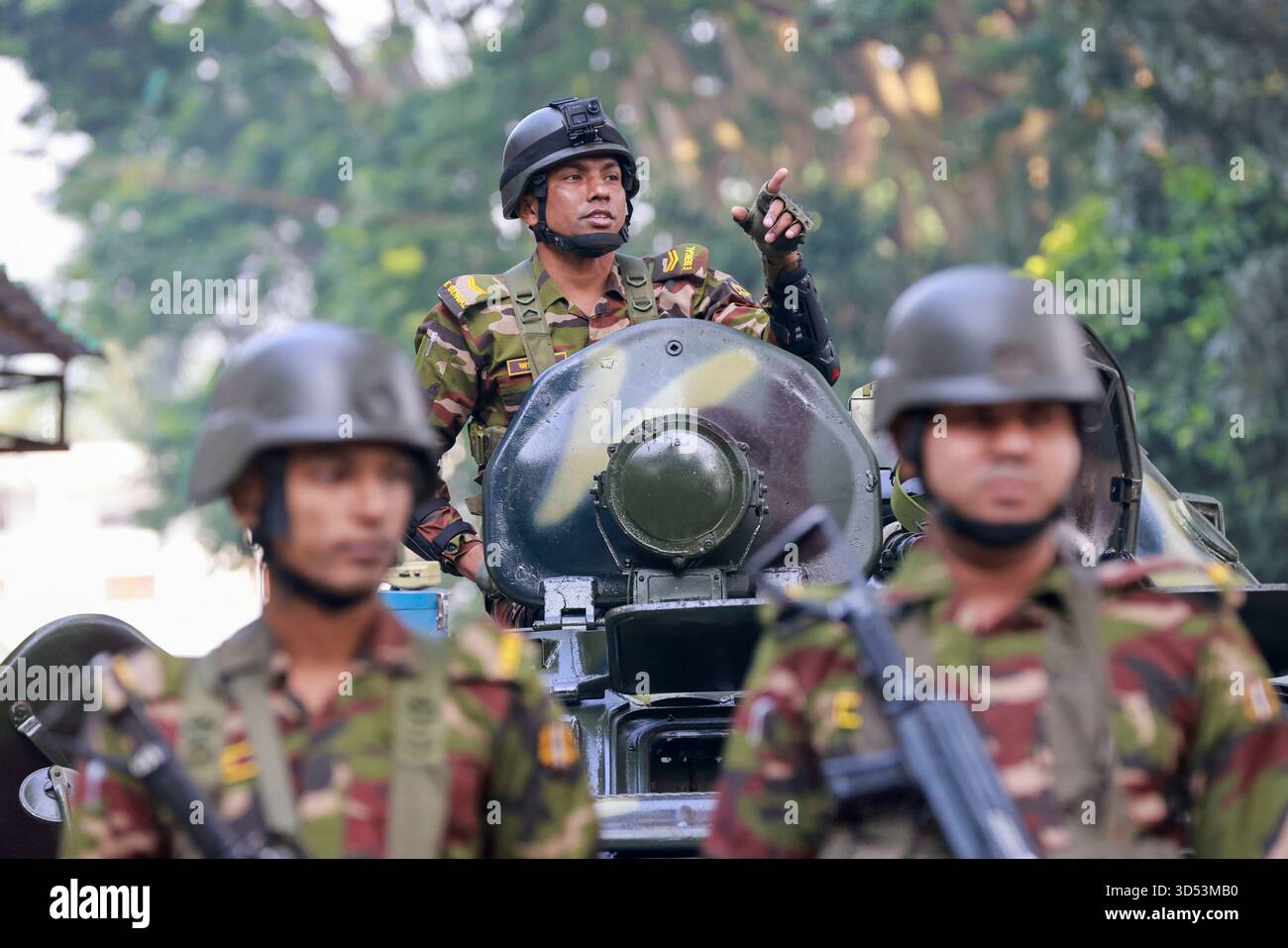 Bangladeshi security personnel stand guard in front of the ...