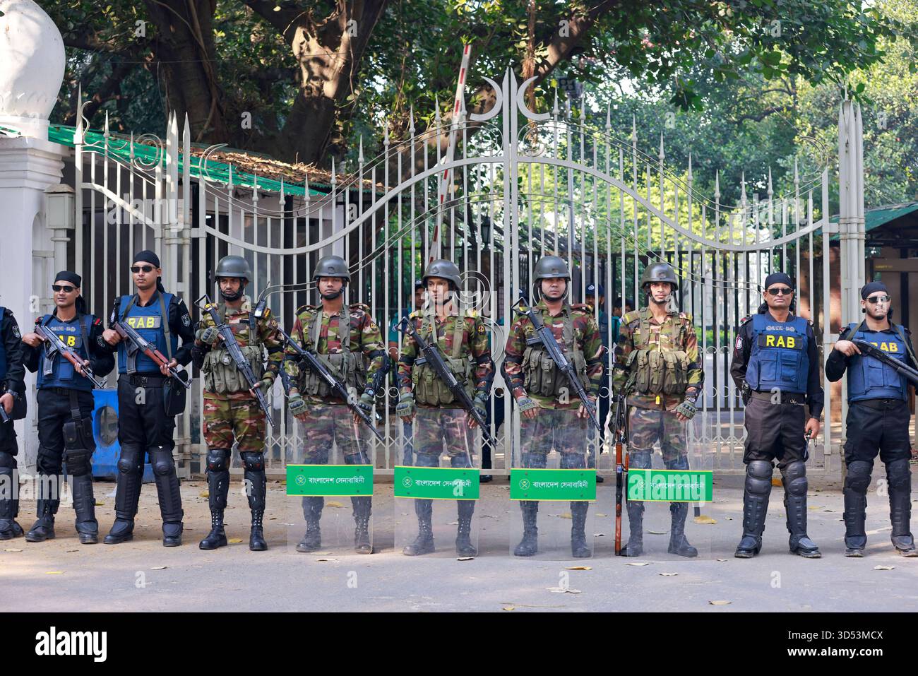 Bangladeshi security personnel stand guard in front of the ...