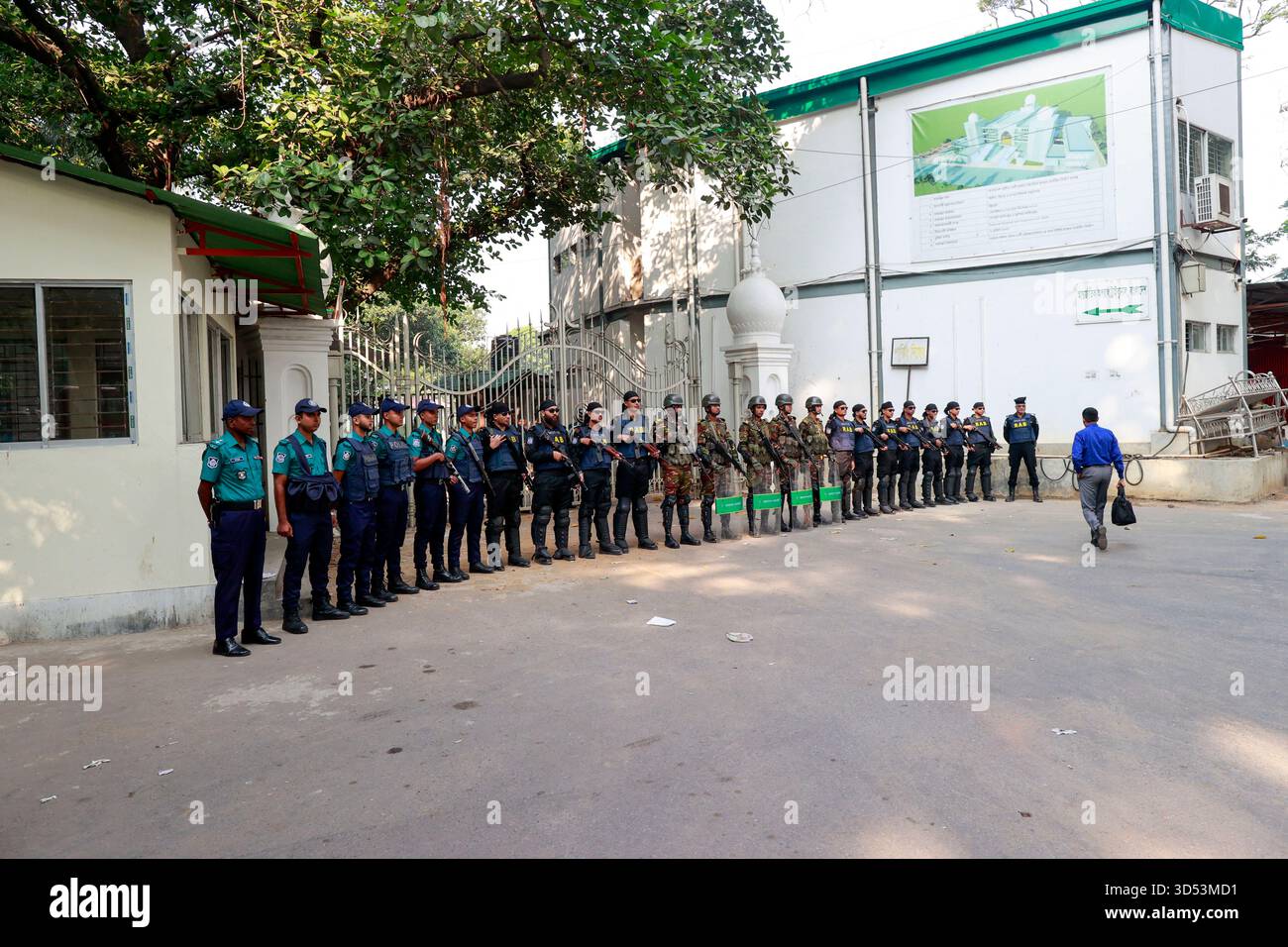 Bangladeshi security personnel stand guard in front of the ...