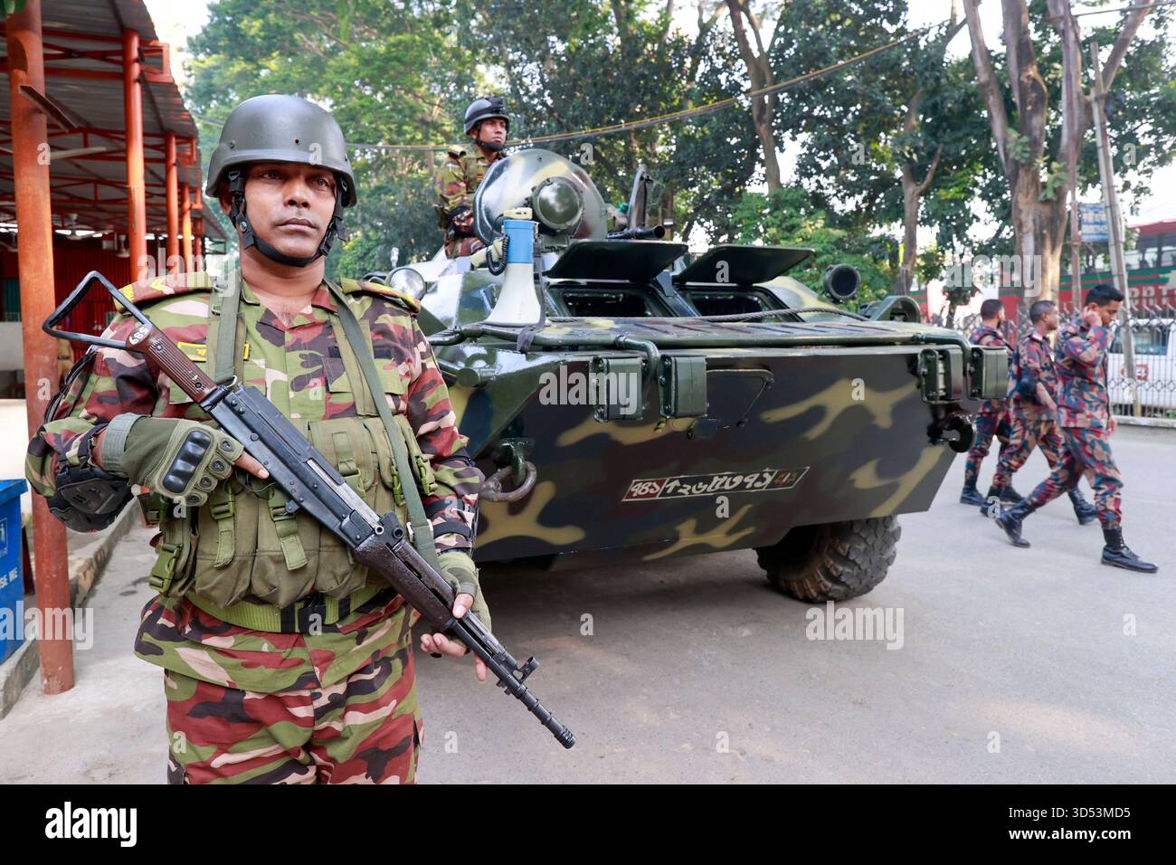Bangladeshi security personnel stand guard in front of the ...
