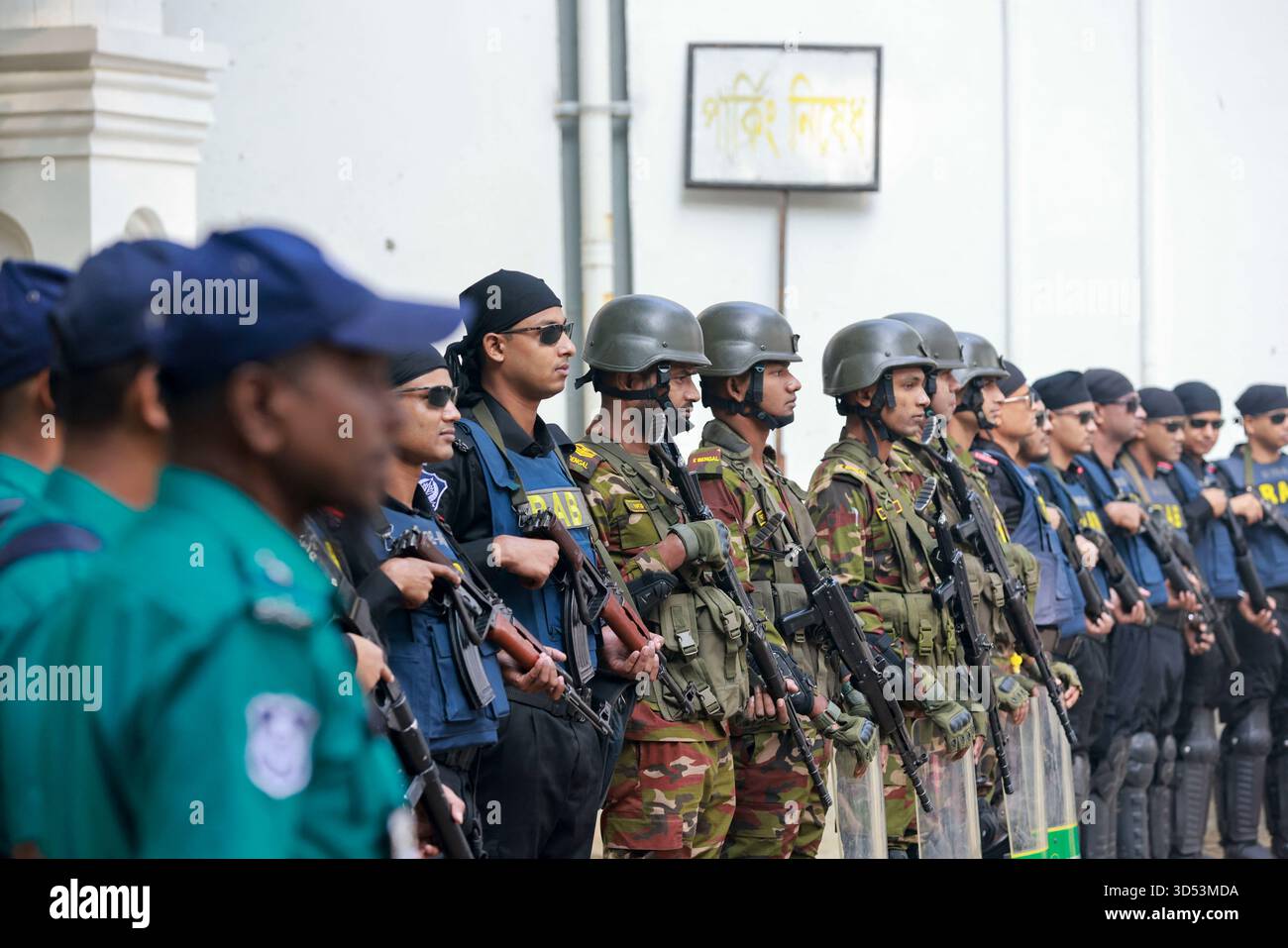 Bangladeshi security personnel stand guard in front of the ...