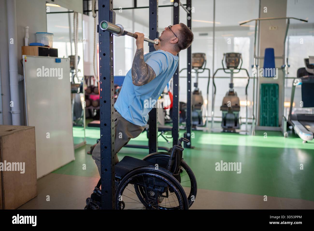 Man in wheelchair doing vertical pull ups workout using adaptive ...