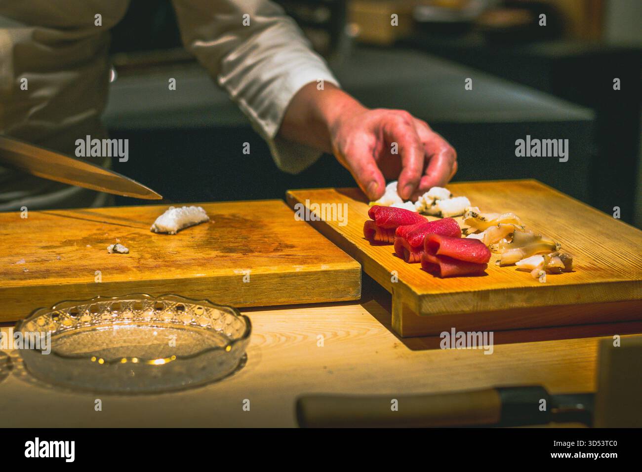 hands of japanese omakase chef preparing sashimi raw fish at counter ...