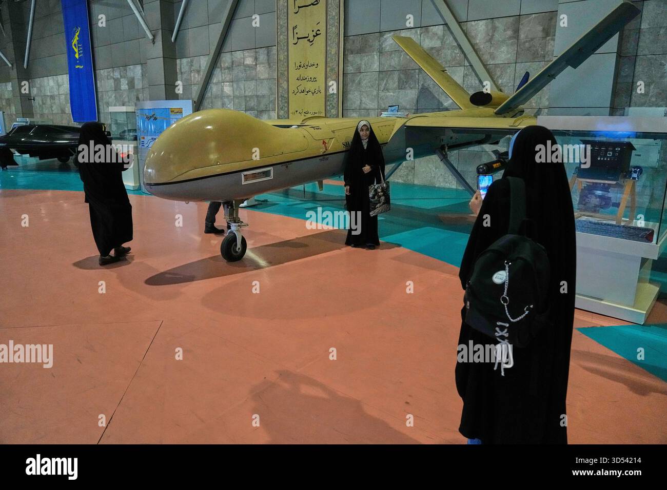 People take picture with Shahed-129 Iranian domestically-built drone as they visit the National ...