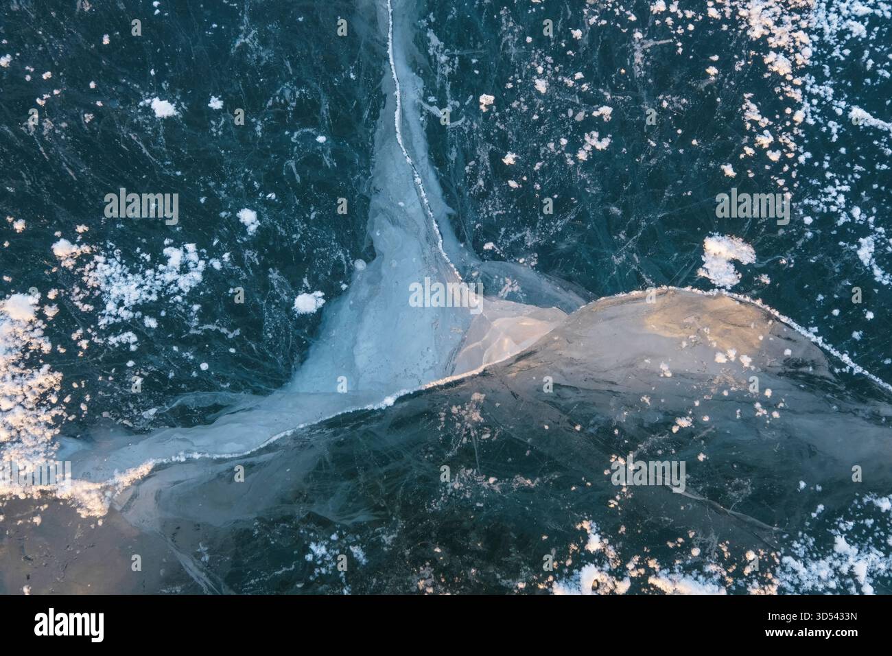 A natural wonder: a deep crack in the ice of a frozen lake. A close-up ...
