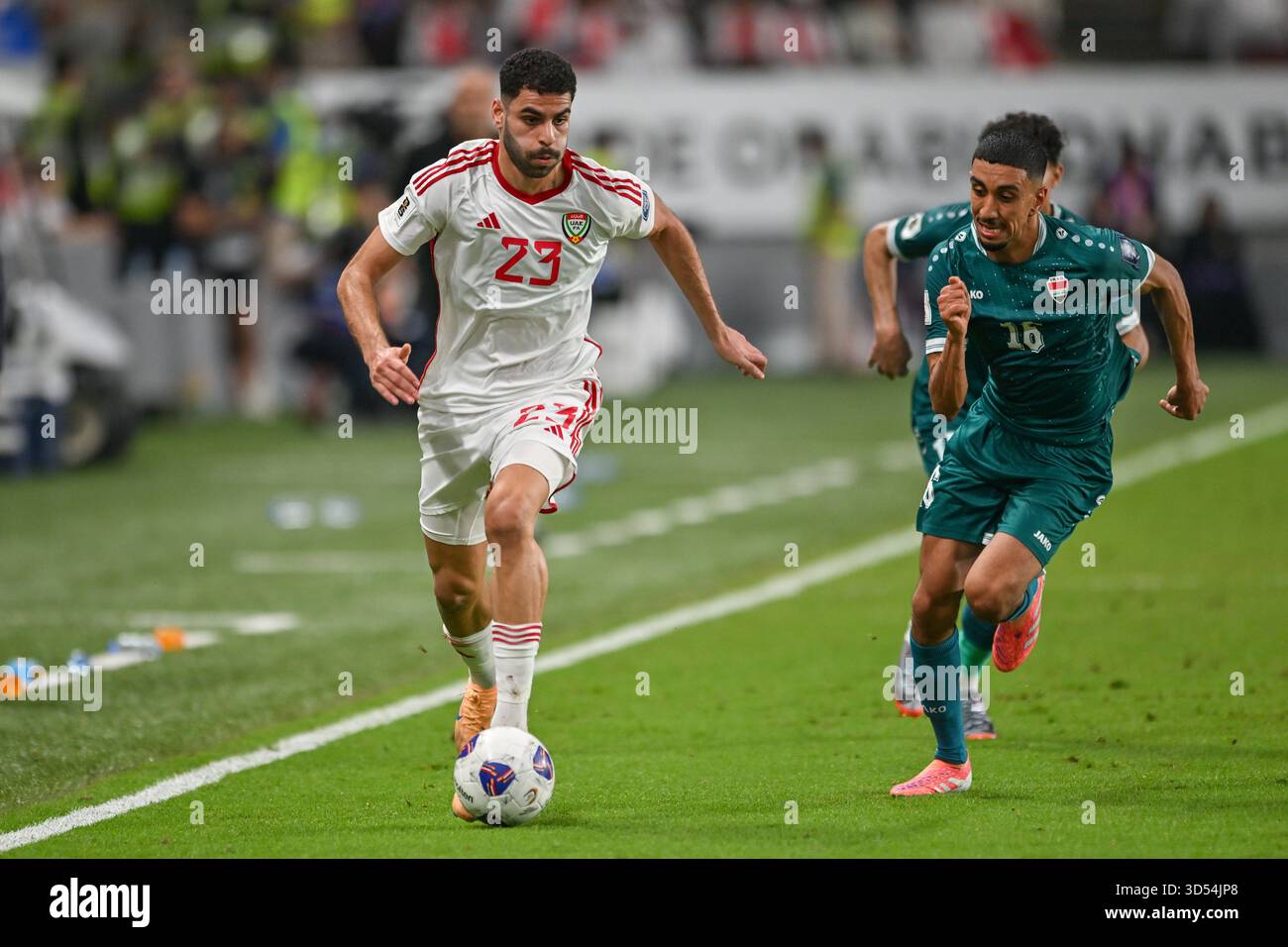 Sultan Adil of the UAE, left, runs with the ball past Iraqi's Amir ...