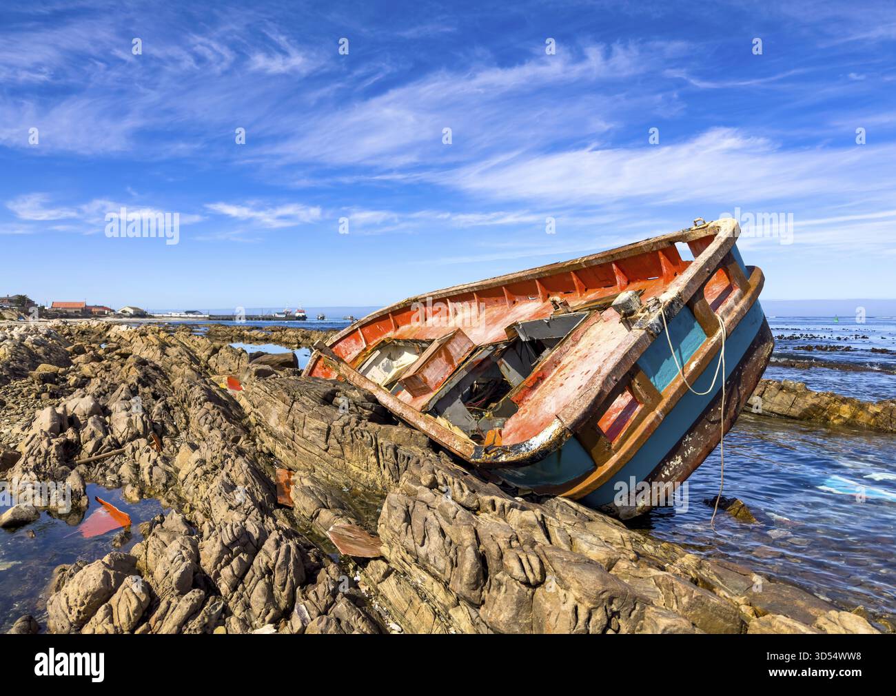 Shipwrecked diamond mining vessel on rocky shoreline in small West ...