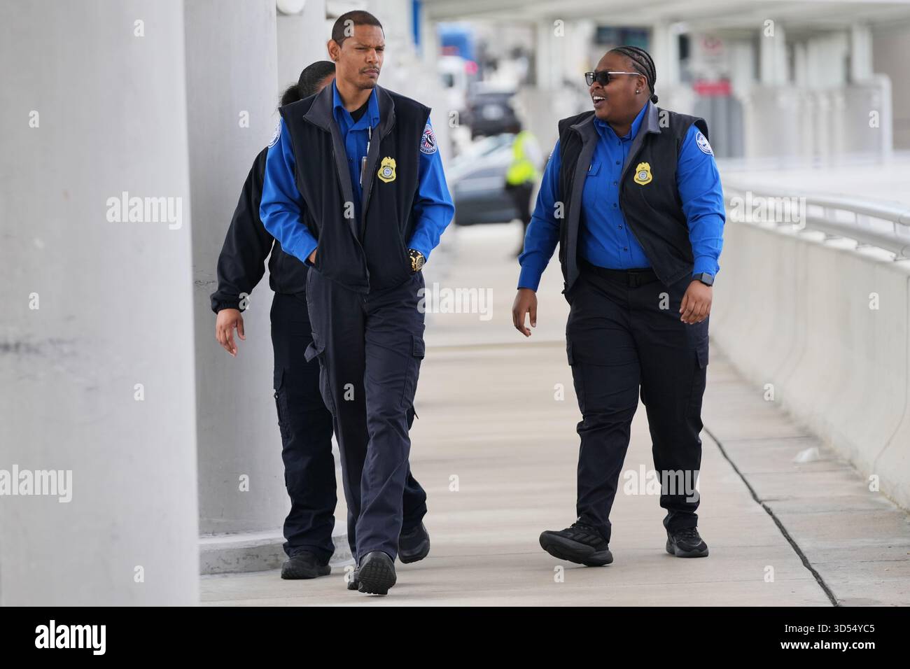 TSA agents walk to the terminal at the Fort Lauderdale-Hollywood ...