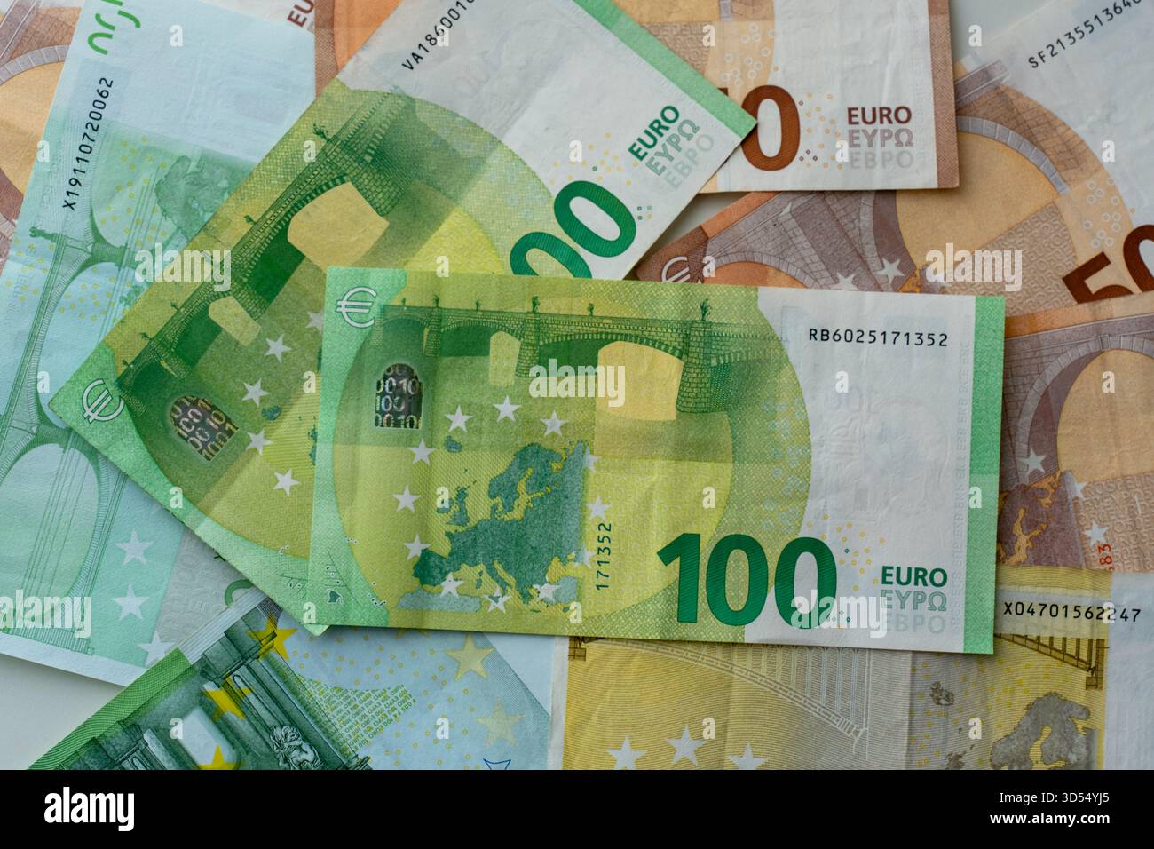 Various euro banknotes spread on surface showing different ...