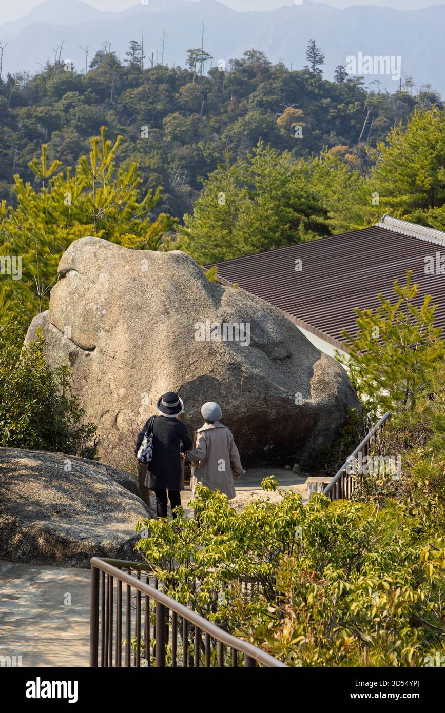 Two elderly Japanese women with hat walking downstairs along the ...