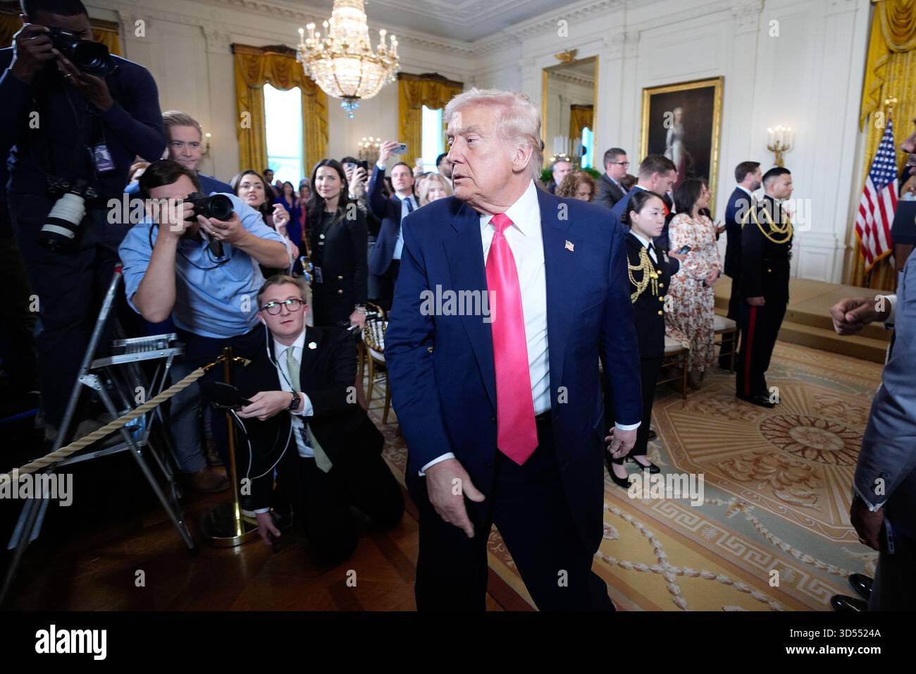US President Donald Trump leaves the signing ceremony for the ...