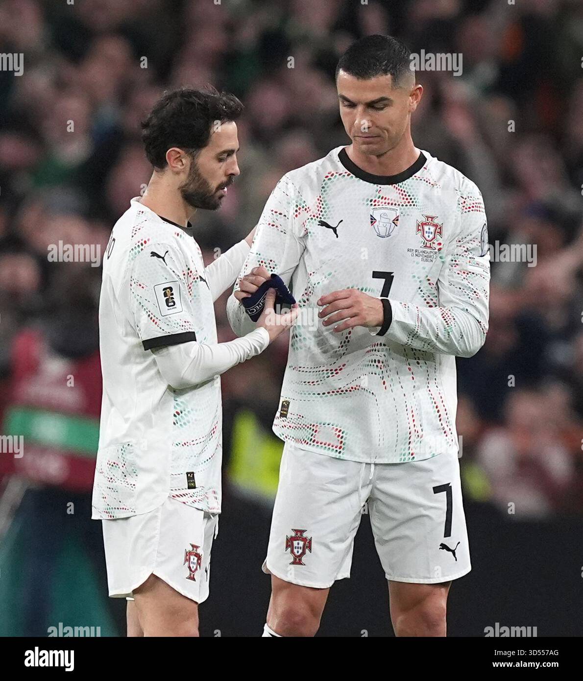 Portugal's Cristiano Ronaldo hands the arm band to team-mate Bernardo ...