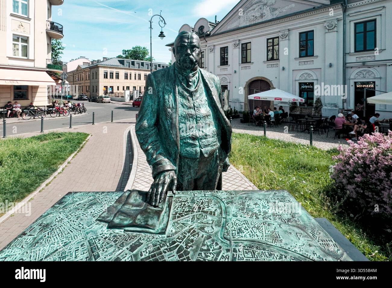 Bronze statue of city mayor Juliusz Leo with a raised city map in a ...