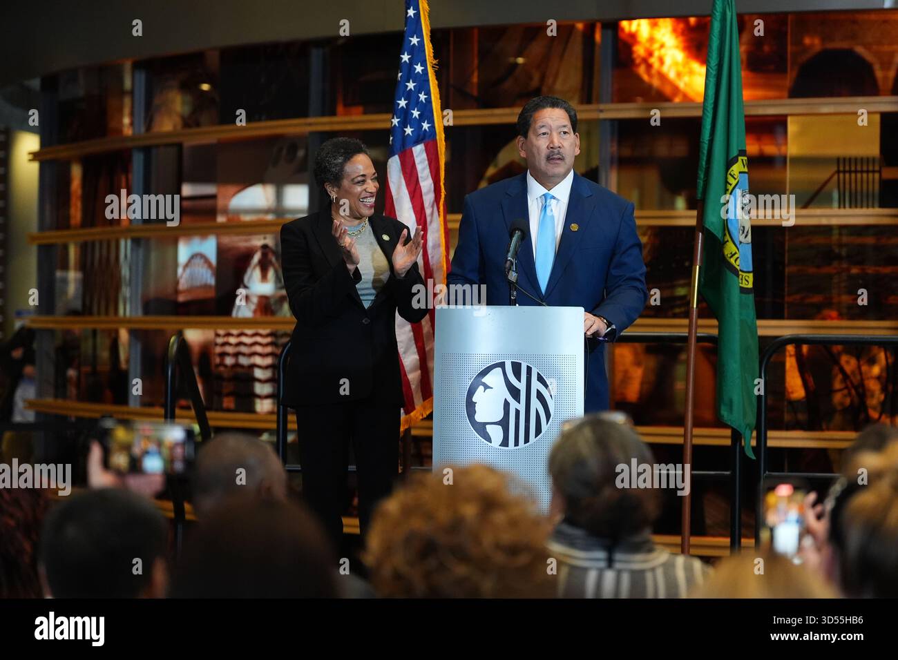 Seattle Mayor Bruce Harrell, right, looks on as wife Joanne Harrell ...