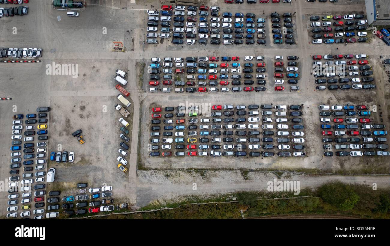 An aerial view of a large outdoor lot filled with numerous vehicles ...