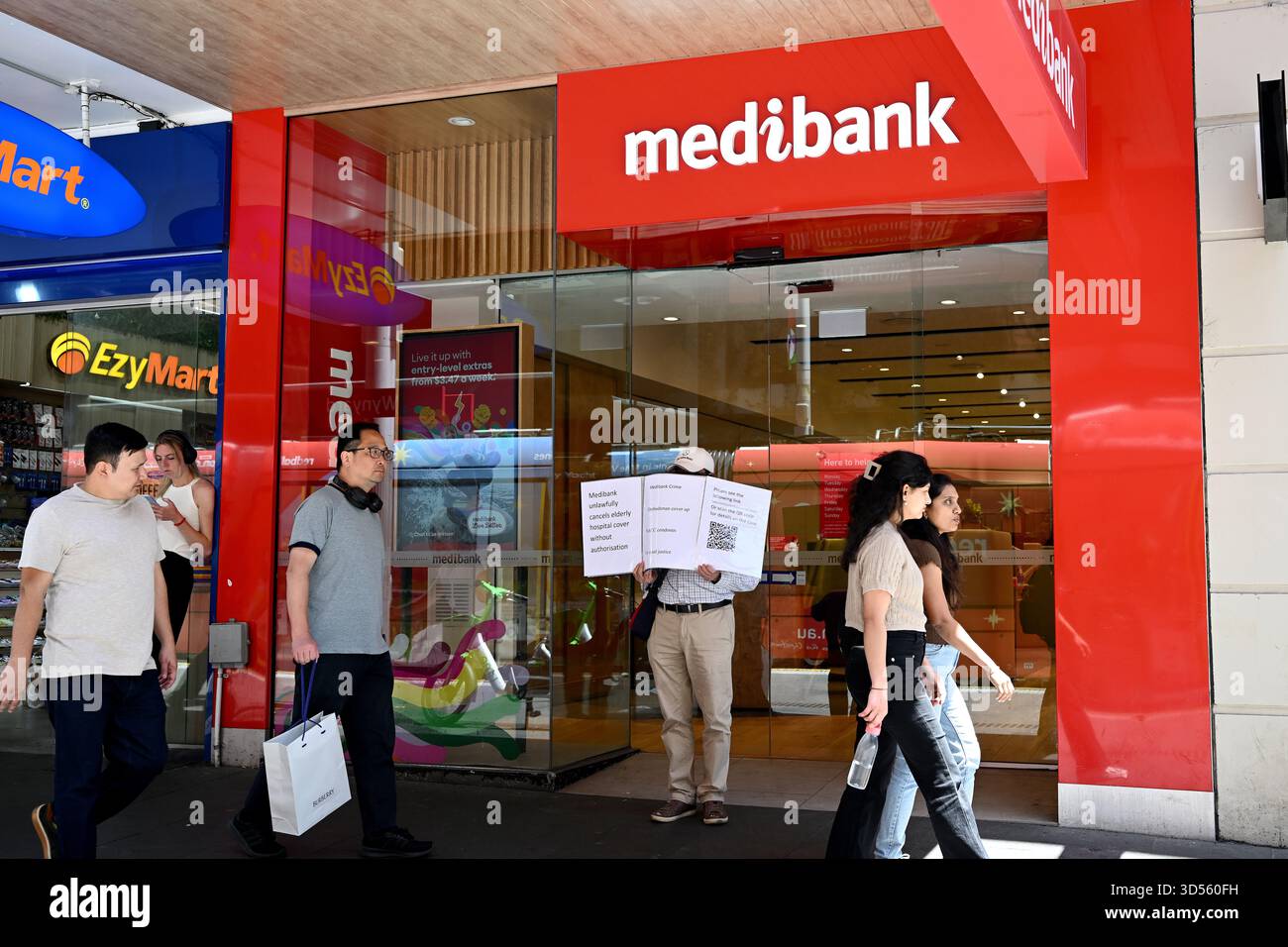People walk past a Medibank store in Sydney, Friday, November 14, 2025 ...