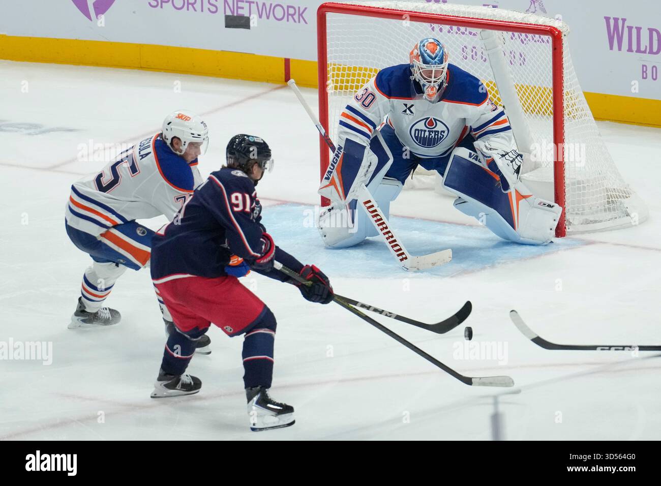 Edmonton Oilers defenseman Alec Regula, left, and center Kent Johnson ...
