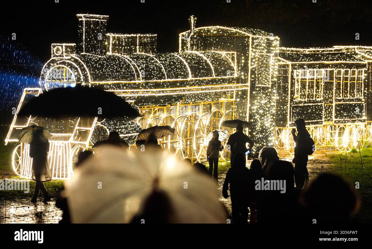 Members of the public make their way around the light trail at the ...