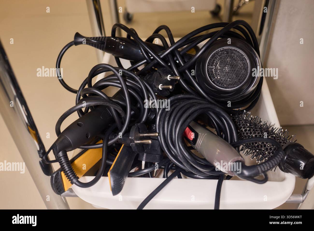 Chaotic styling station, Messy salon tools and cables, Disorganized ...