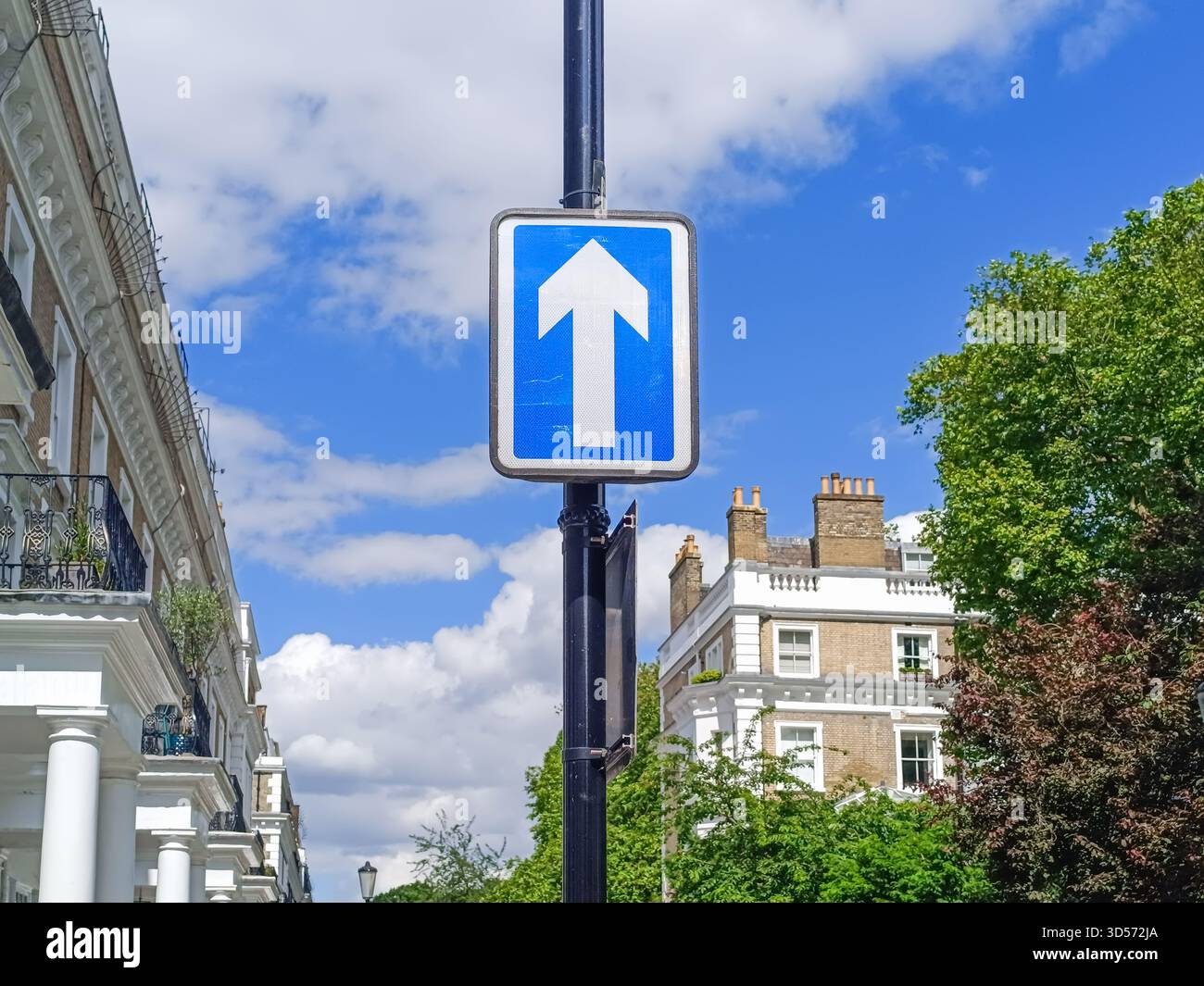 One Way Traffic Sign on UK Residential Street with Blue Arrow and Urban ...