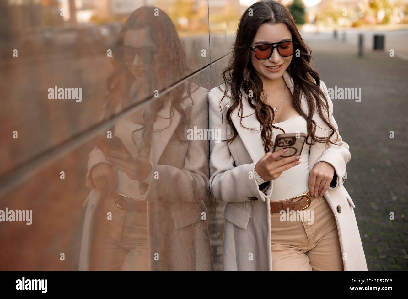 Woman sunglasses using smartphone hi-res stock photography and images ...