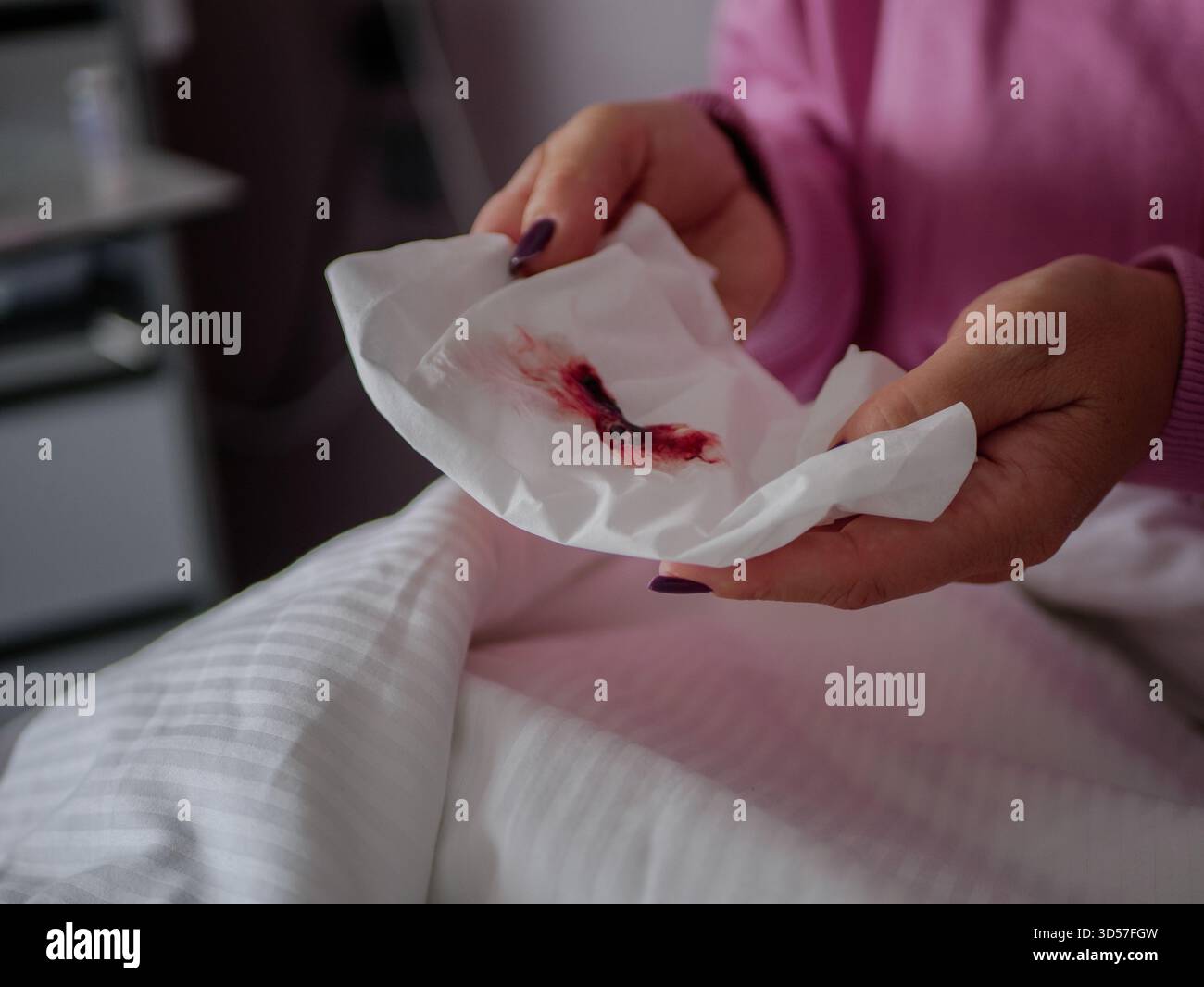 Patient holding bloody tissue hospital Stock Photo - Alamy
