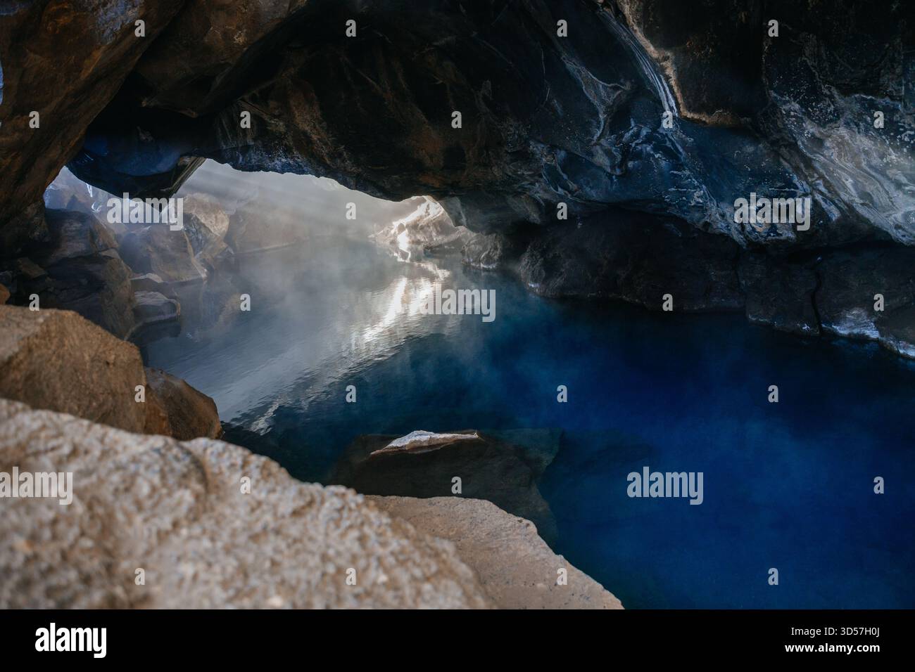 The Grjótagja volcanic cave, with its blue, hot thermal water, is ...