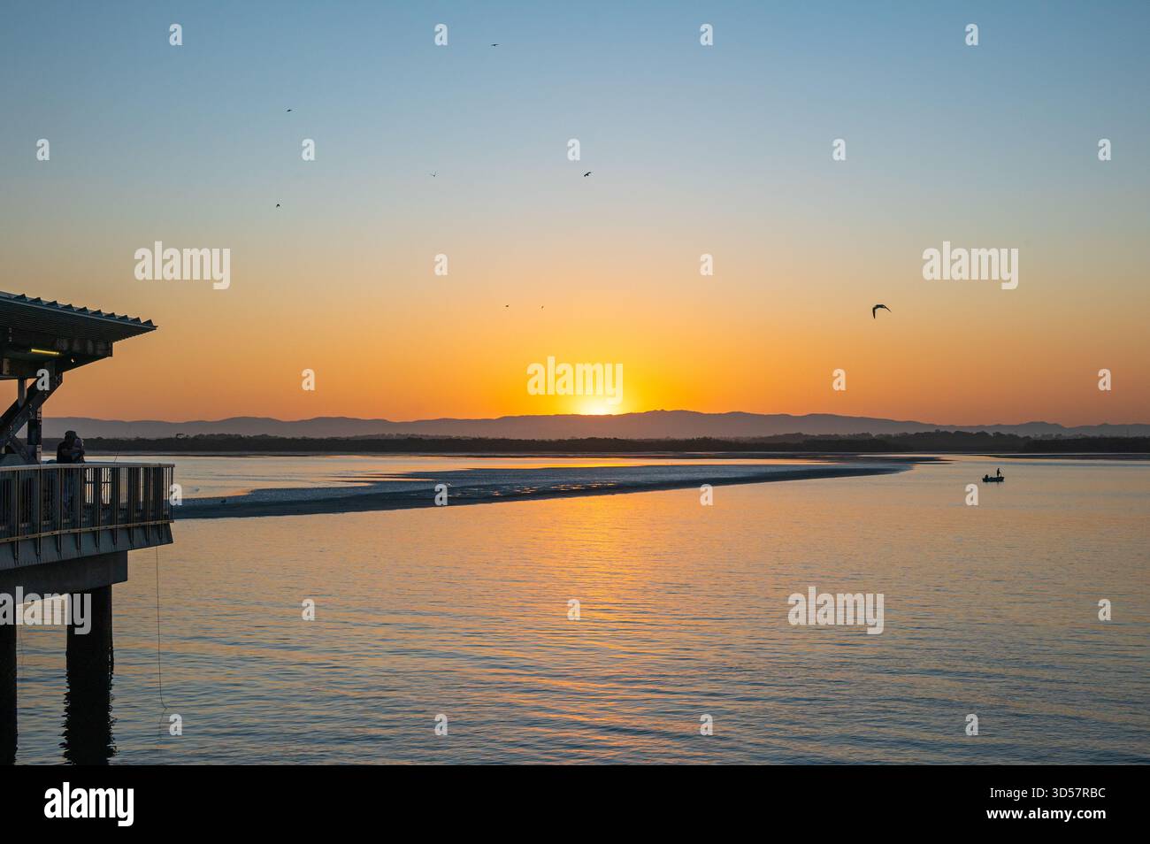 A colourful sunset over the Pine River Estuary as seen from Hornibrook ...