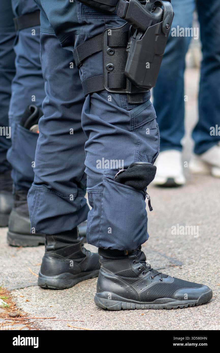 Boots and tactical pants of a police officer on a city street Stock ...
