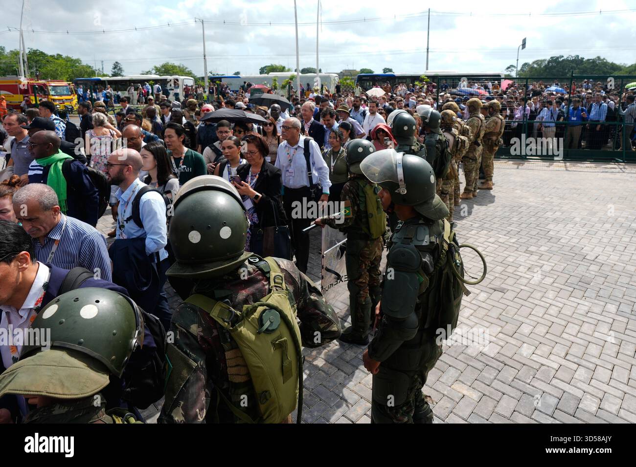 Attendees wait to get into the venue for the COP30 U.N. Climate Summit ...