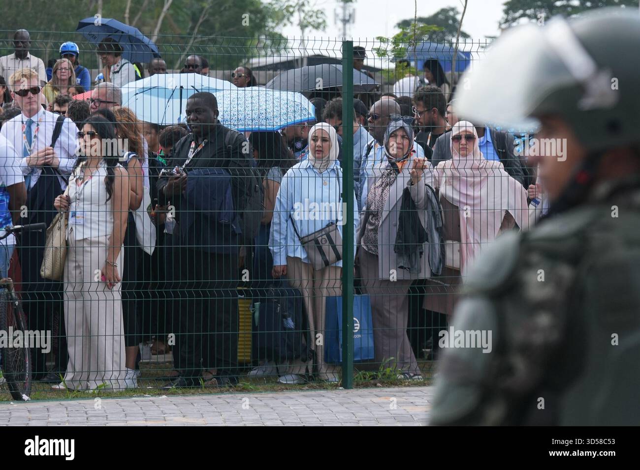 Attendees wait to get into the venue for the COP30 U.N. Climate Summit ...