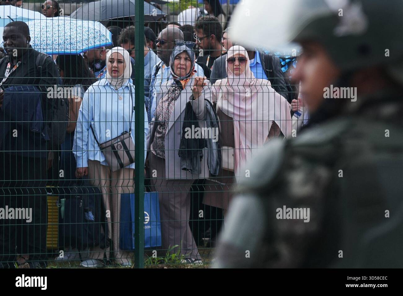 Attendees wait to get into the venue for the COP30 U.N. Climate Summit ...