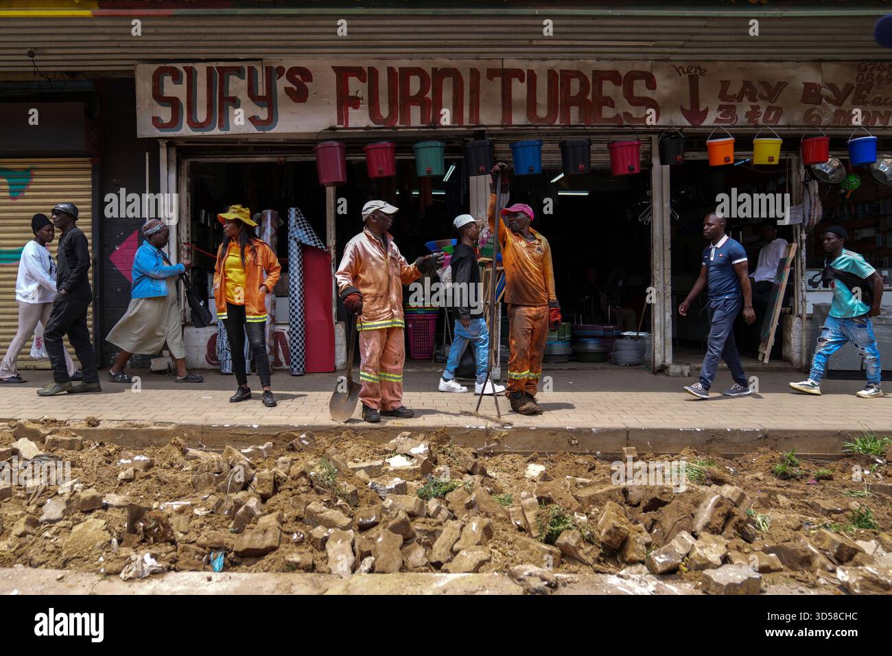 Workers fix a road in Johannesburg's Soweto township as a massive ...