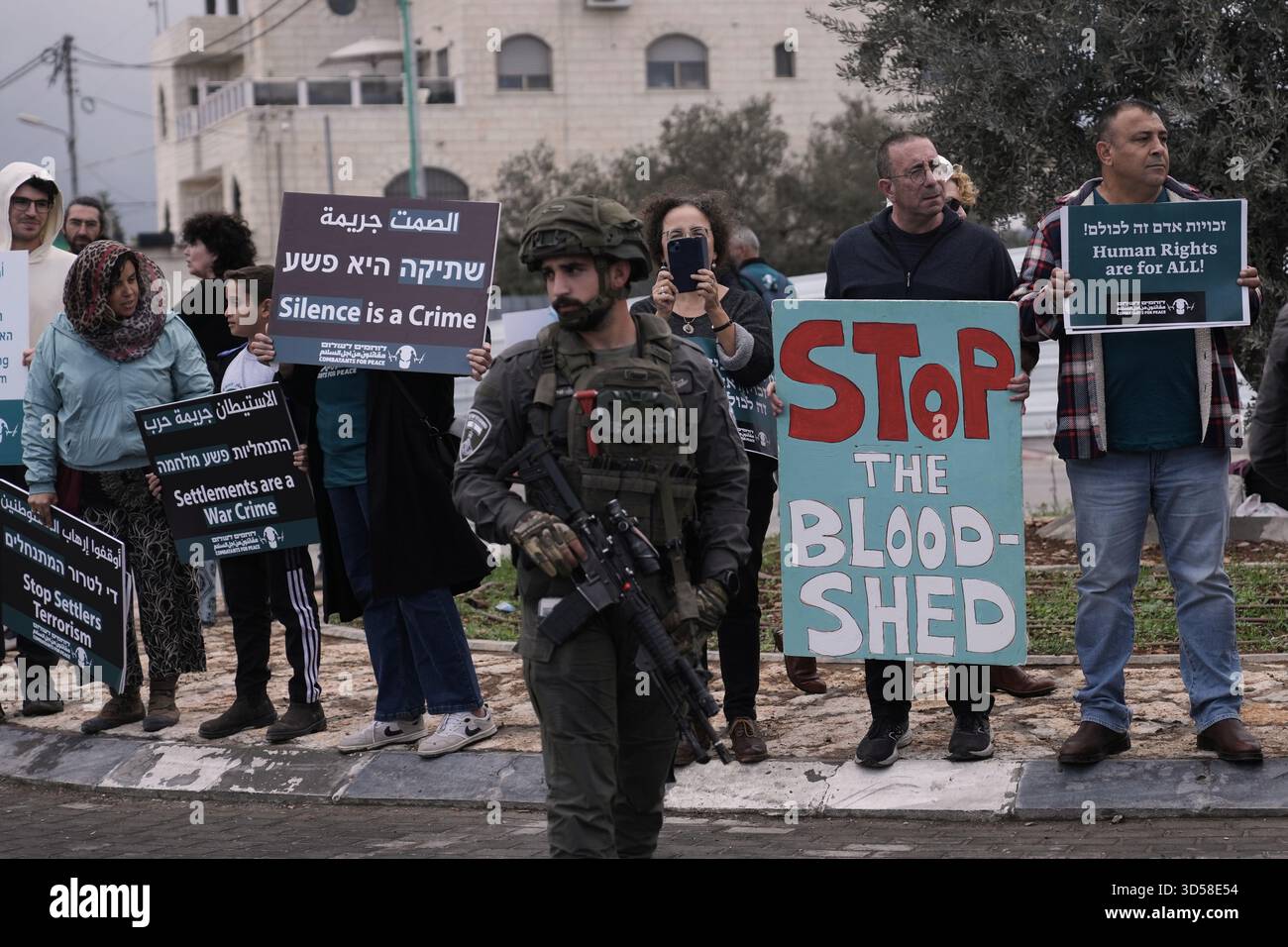 Palestinian and Israeli activists take part in a protest against the ...