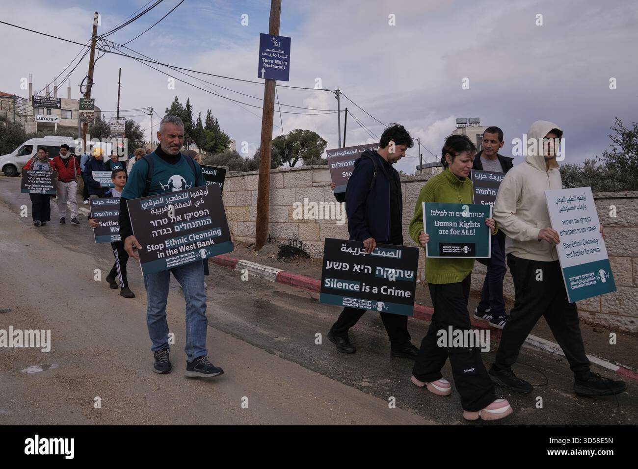 Palestinian and Israeli activists take part in a protest against the ...