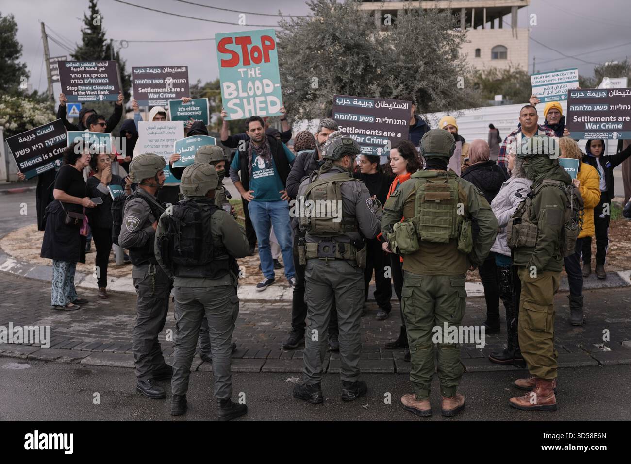 Palestinian and Israeli activists take part in a protest against the ...