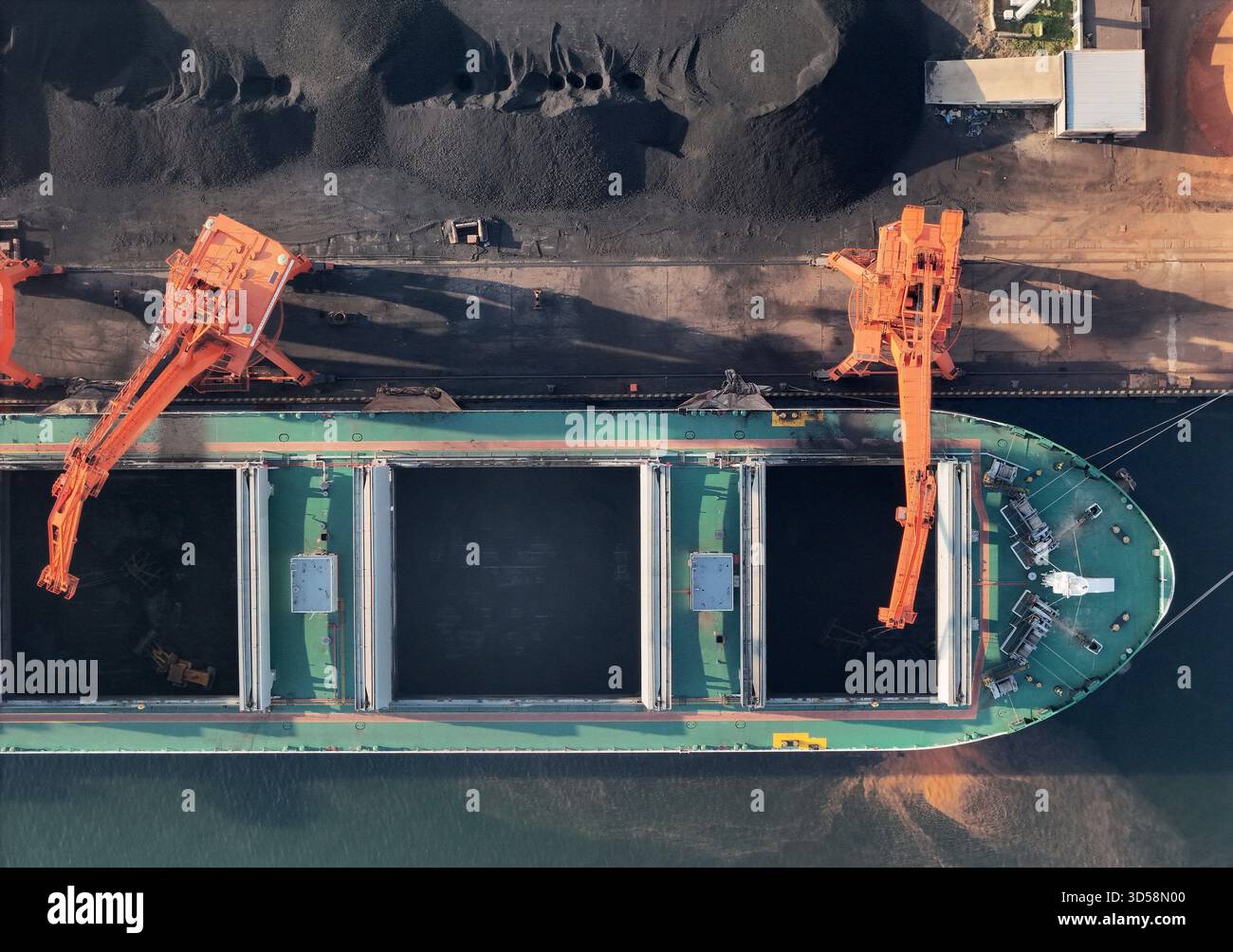 Machines work at a coal storage dock in Longkou in east China's ...