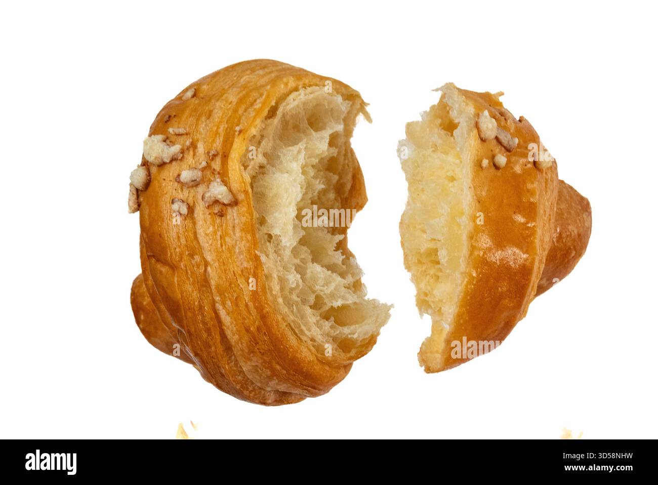 Bite taken from croissant revealing fluffy crumb and crisp texture ...