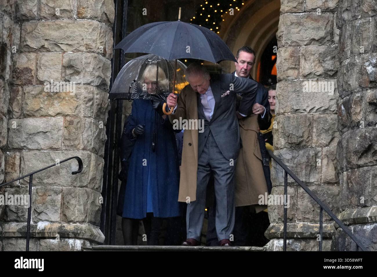 Britain's King Charles III and Queen Camilla leave after joining a ...
